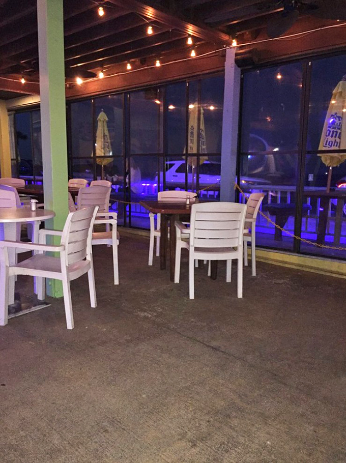 Evening ambiance at its finest &ndash; soft lighting, cozy seating, and large windows that frame the Atlantic's nighttime beauty.