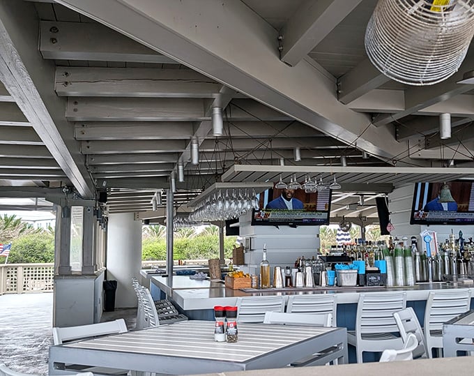 Interior: Where coastal elegance meets casual comfort &ndash; white beams, hanging glassware, and sea breezes create the perfect backdrop for culinary magic.