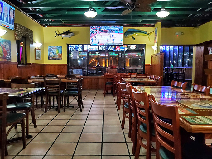 Yellow walls and mounted fish create that authentic "yes, you're really in Florida" vibe that no corporate designer could ever replicate.