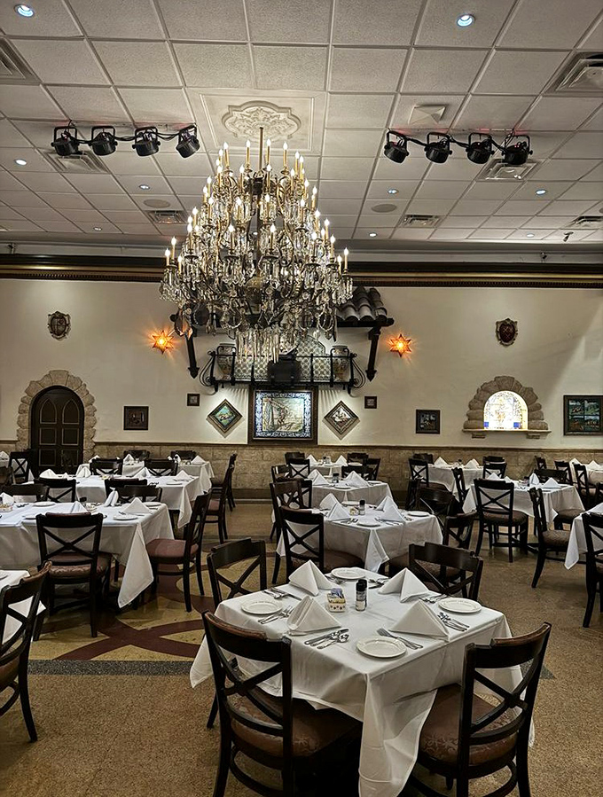 Crystal chandeliers cast a warm glow over crisp white tablecloths, creating an atmosphere where time slows down and conversations flow as freely as the sangria.