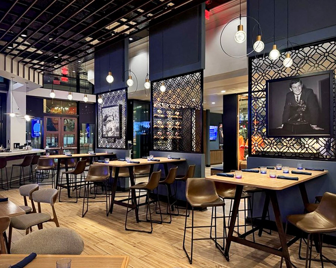 Interior: Modern elegance meets sports heritage in this thoughtfully designed dining room where geometric screens create intimate spaces without sacrificing openness.