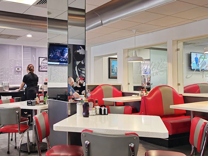 Classic red and silver booths invite diners to slide in and stay awhile, creating the perfect backdrop for conversations that flow as freely as the coffee.