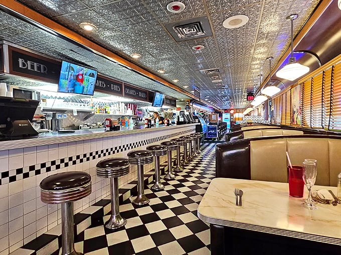 Classic black and white checkered floors meet chrome accents and cozy booths &ndash; this isn't decoration, it's a genuine slice of mid-century dining perfection.