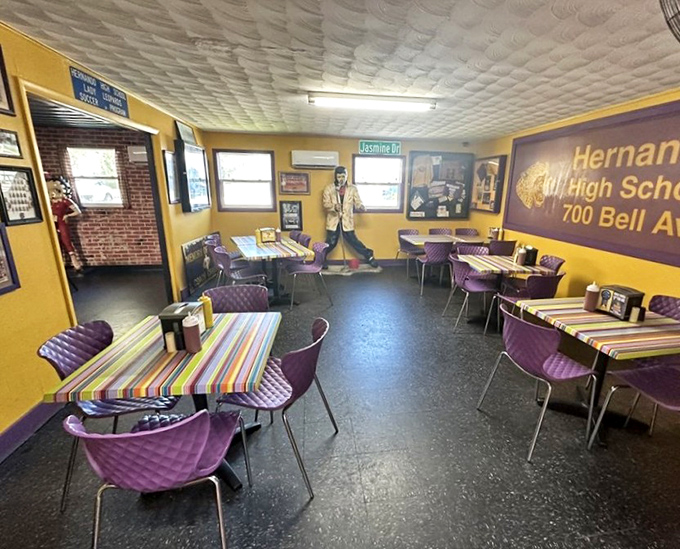 Step inside to discover walls adorned in Hernando High's purple and gold, where local memorabilia transforms dining into a community experience.