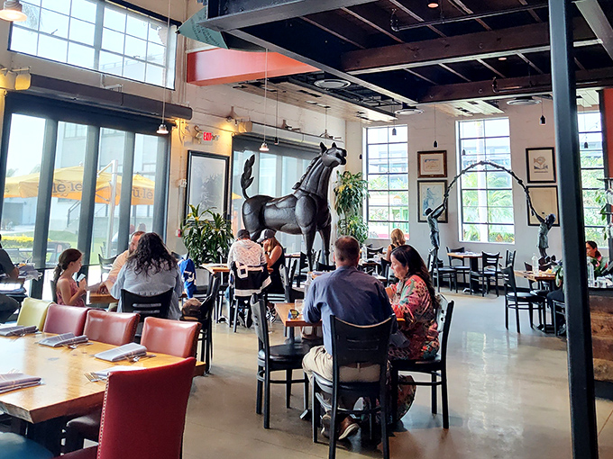 Inside Ulele, a magnificent horse sculpture commands attention amid the industrial-chic dining room, where history meets culinary innovation.