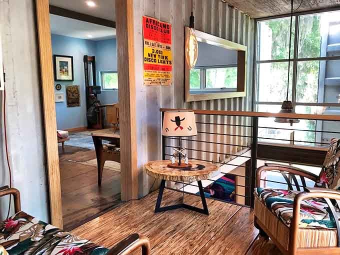 Step inside and discover that shipping containers can indeed feel spacious and inviting, with industrial elements softened by warm wood and artistic touches.