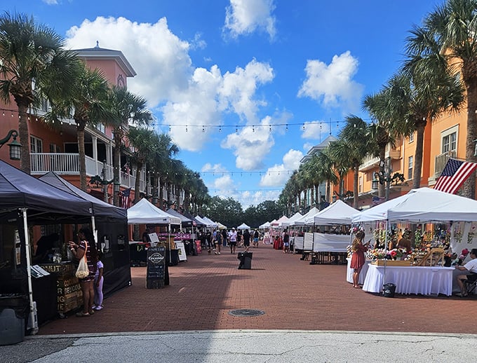 Sunlight dapples through palm fronds onto the brick-paved thoroughfare where locals and visitors mingle among artisan offerings.