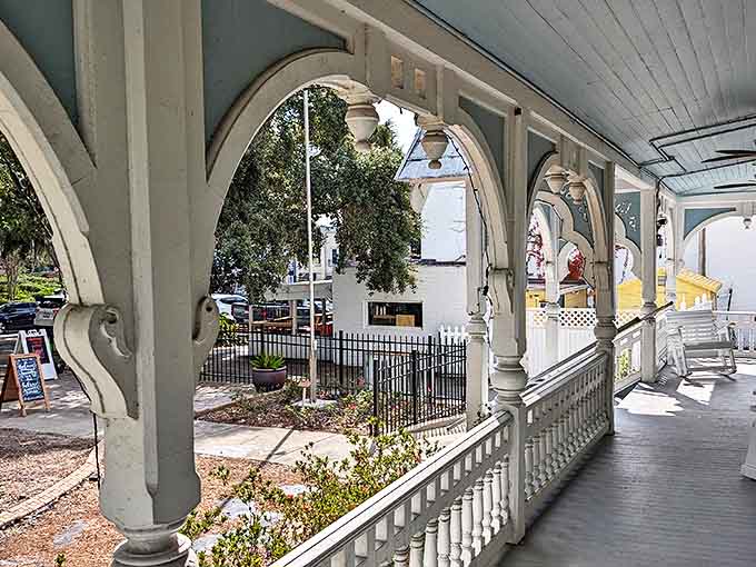 Porch perspectives: Graceful arches frame the wraparound porch where rocking chairs await brave souls willing to sit a spell with history.