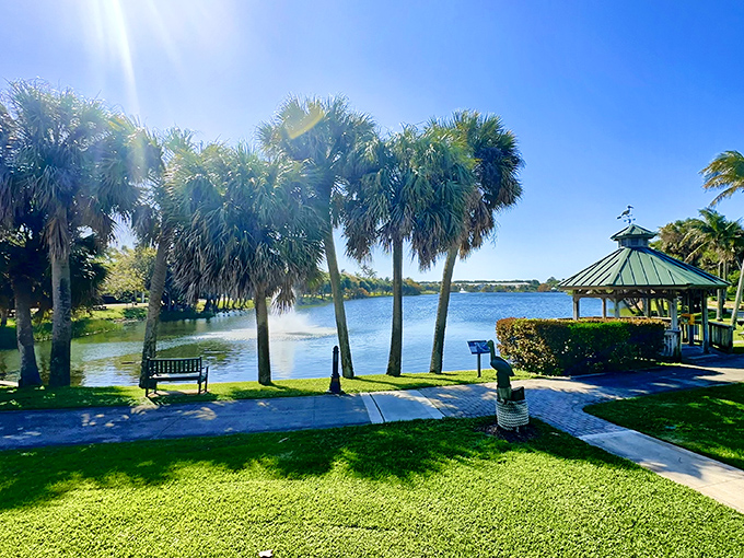 Palm trees stand guard around this waterfront gazebo, offering shade and serenity like nature's version of an exclusive cabana.
