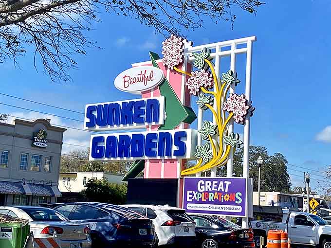 The iconic Sunken Gardens sign stands as a cheerful sentinel, its retro charm promising tropical wonders just beyond the parking lot.