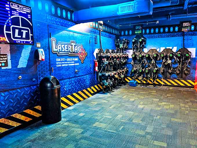 The laser tag staging area glows with sci-fi promise, transforming ordinary humans into tactical warriors with each vest that comes off the rack.