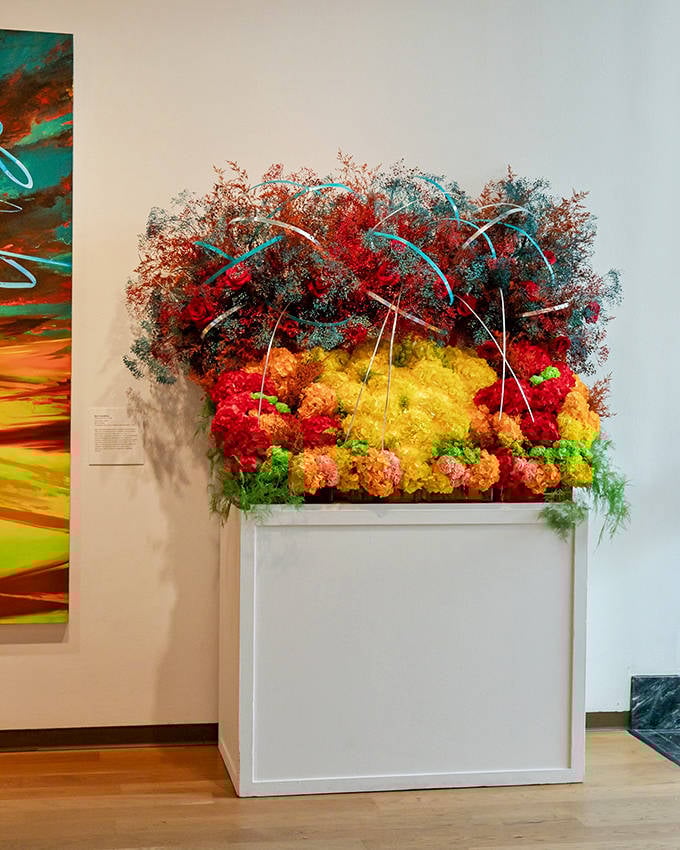 A stunning floral arrangement bursts with color at Art in Bloom, transforming museum spaces into living works of art.