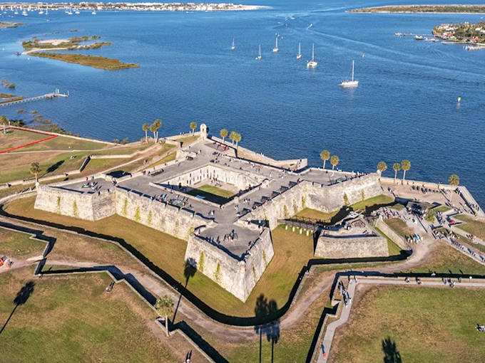 Castillo de San Marcos stands as a mighty star-shaped fortress overlooking the water, its coquina walls having withstood centuries of storms and sieges.