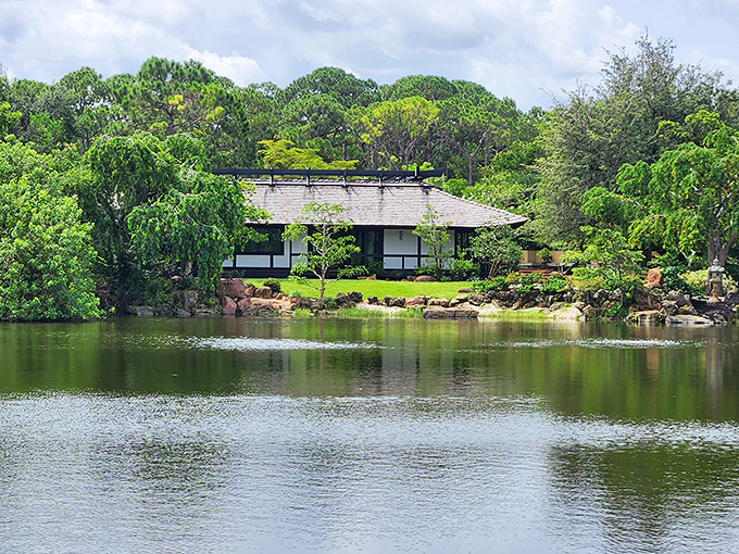 Morikami's traditional Japanese house reflects perfectly in the still pond waters, creating a peaceful haven that feels worlds away from Florida.