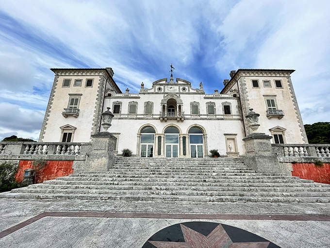 Grand stone steps lead to Vizcaya's main entrance, where Mediterranean splendor meets Florida's tropical landscape.