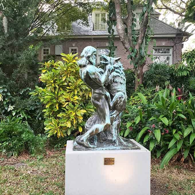 Bronze figures locked in eternal struggle, proving that even sculptures have their dramatic moments in the garden spotlight.