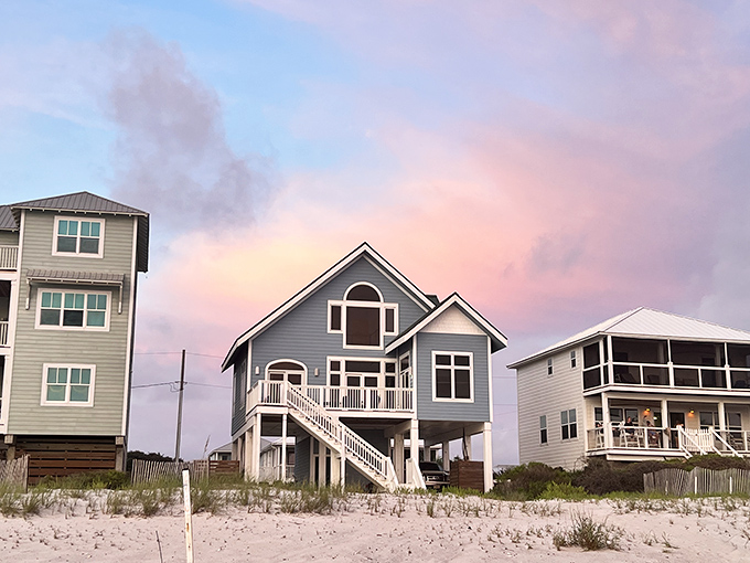 Colorful beach houses on stilts dot the shoreline, their pastel hues glowing against cotton candy skies at dusk.