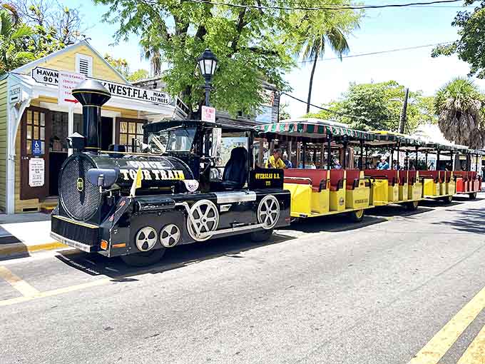 The locomotive-styled engine pulls its cheerful yellow cars through Old Town, a rolling postcard of Key West's unique character.