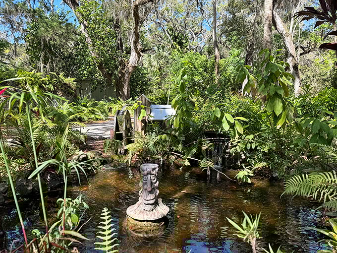 A peaceful pond that reflects the surrounding greenery like nature's own mirror, proving that sometimes the best water features are the ones that just sit there looking pretty and attracting dragonflies.
