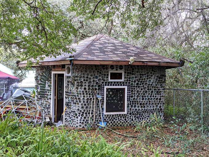 The bottle house's exterior showcases meticulous craftsmanship, with thousands of colorful glass bottles embedded in concrete to create walls that shimmer like jewels.