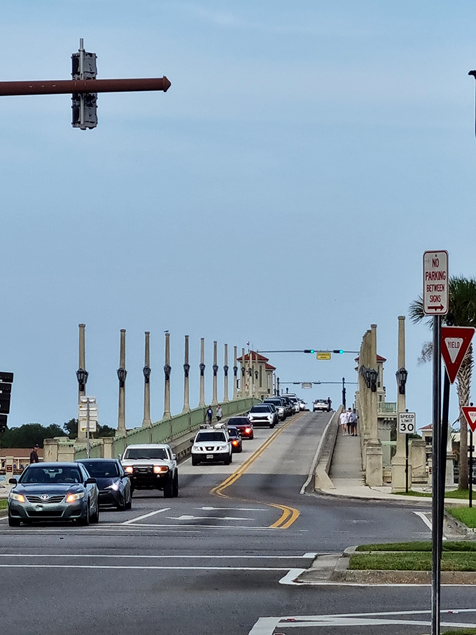 Traffic flows across the span while boats wait patiently below – a daily dance between land and sea transportation.