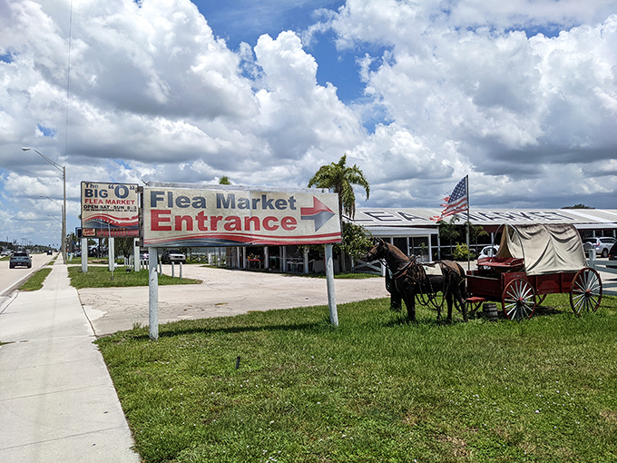 Horse-drawn carriage meets flea market entrance &ndash; a charming time warp that sets the stage for vintage adventures within.