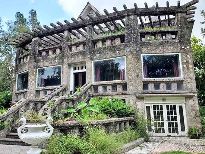 The front facade showcases the creator's obsession with unconventional design – concrete steps sweep upward like welcoming arms to this temple of eccentricity.