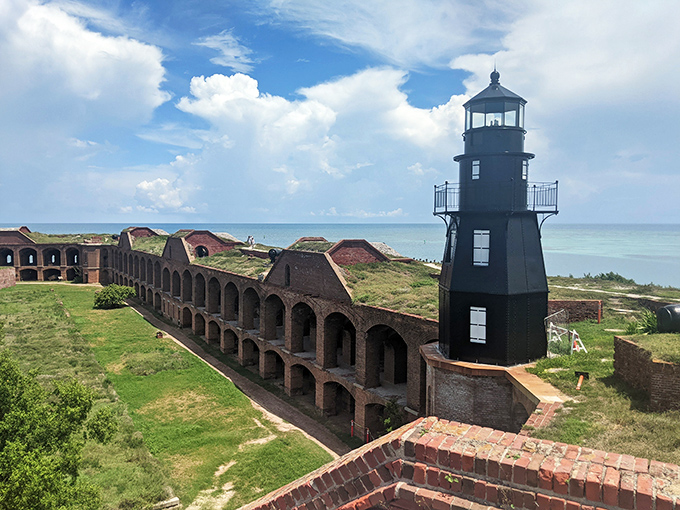 The historic Garden Key lighthouse keeps watch alongside Fort Jefferson, a faithful sentinel guiding mariners through these crystal waters since 1876.