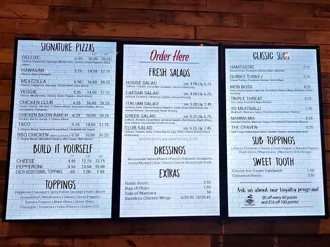 The menu board displays a tempting array of signature pizzas and build-your-own options for every craving.