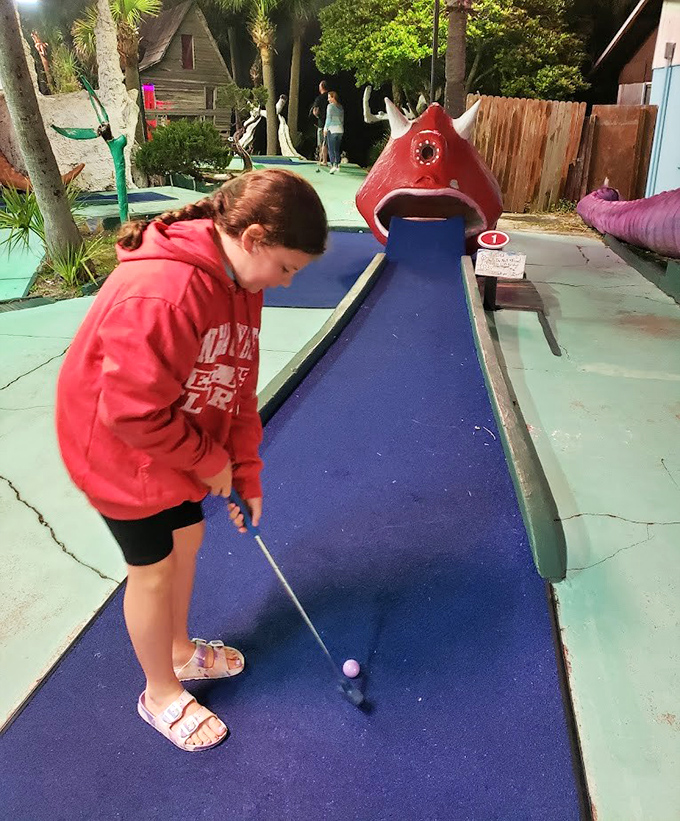 Concentration etched on her face, a young golfer lines up her shot, unaware she's creating memories that will outlast her childhood.