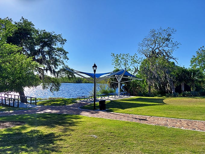 Sunlight dapples through shade sails as the tranquil shoreline offers a perfect respite from life's chaos.
