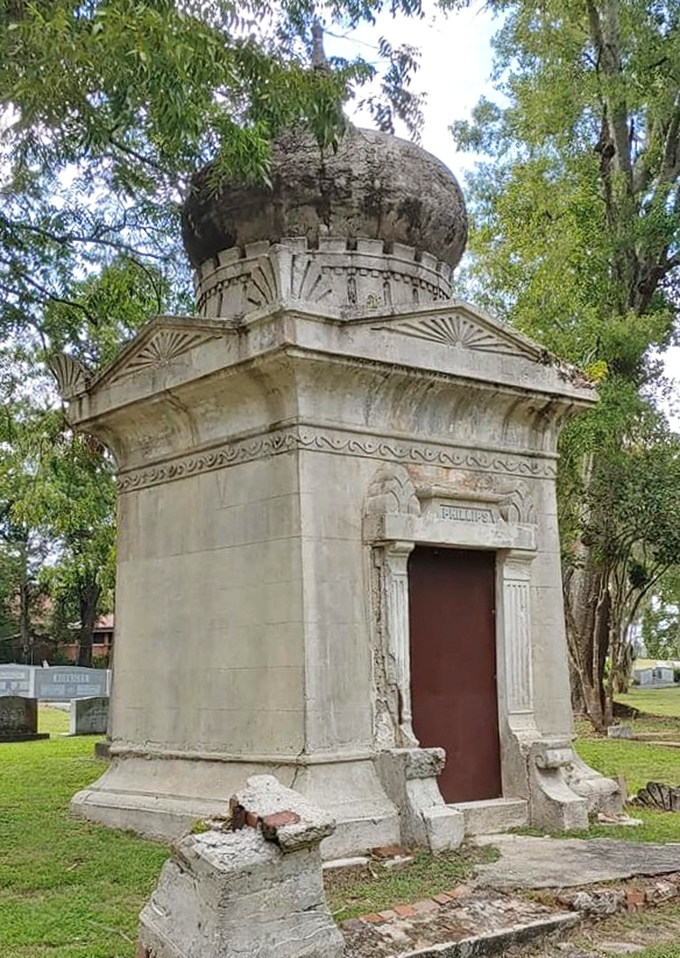 Sunlight plays across the mausoleum's weathered surface, highlighting intricate details that have withstood Florida's relentless seasons for generations.