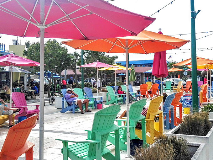 Technicolor Adirondack chairs invite beachgoers to take a load off under equally vibrant umbrellas – Florida's version of a living room.