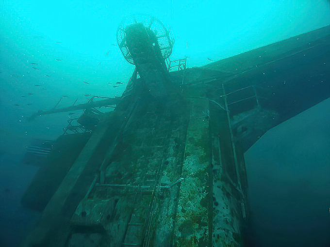 Decades underwater have transformed military corridors into marine habitats, where rust and coral create an otherworldly landscape for adventurous divers.