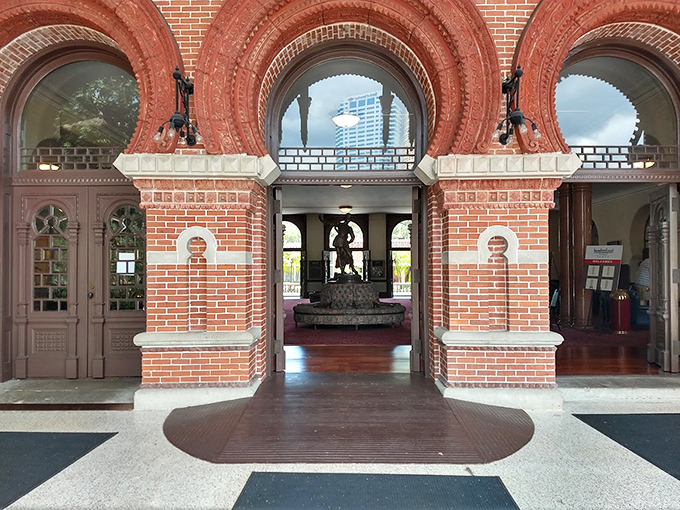 Moorish-inspired arched entrances frame the museum's interior, creating a dramatic portal between present day Tampa and the Gilded Age splendor within.
