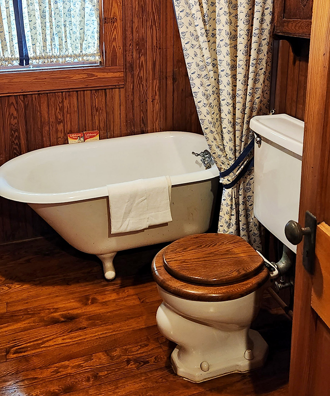 The vintage bathroom features a classic claw-foot tub and wooden accents, making modern spa retreats seem sterile by comparison.