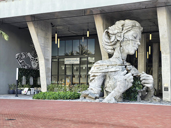 The sculpture's serene expression creates a striking contrast with its fractured stone skin &ndash; like finding unexpected tranquility in life's broken moments.