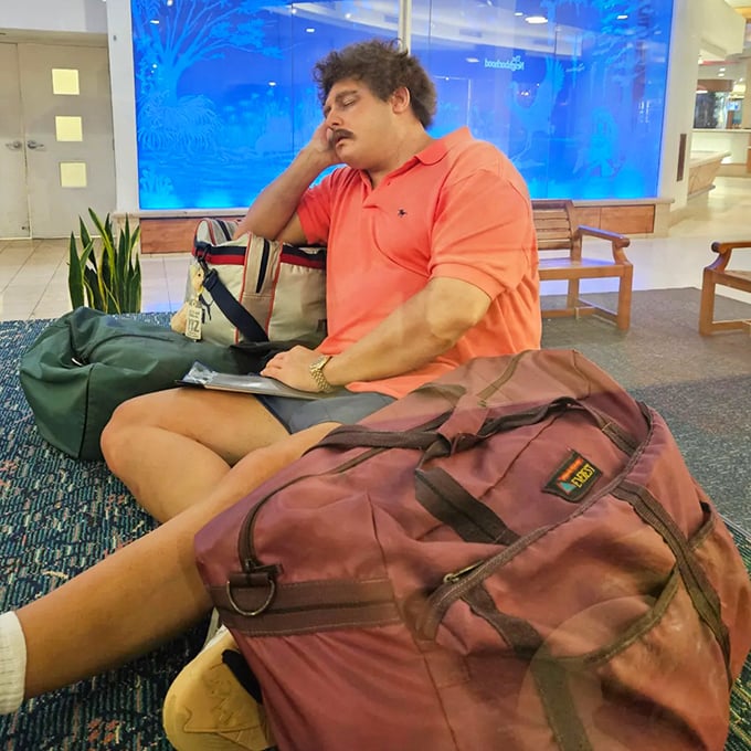 Those vintage duffel bags tell their own silent stories of adventures past, perfectly complementing our eternally patient traveler.