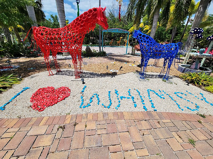 Red and blue equine sculptures stand in silent conversation, their vibrant colors creating a perfect Instagram moment for art lovers and color enthusiasts alike.