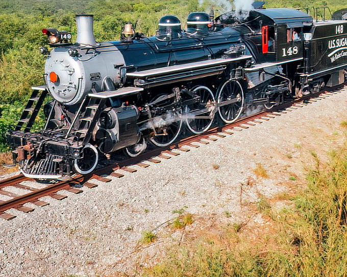 Steam locomotive #148 stands proud, its gleaming black finish and intricate engineering a testament to American industrial artistry.