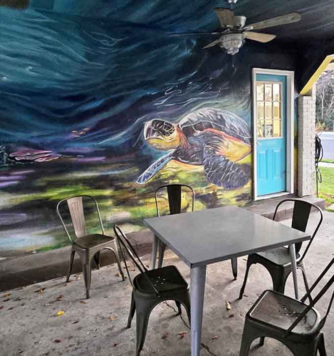 A vibrant sea turtle mural transforms this outdoor patio into an underwater fantasy, perfect for pre-show gatherings and intermission conversations.