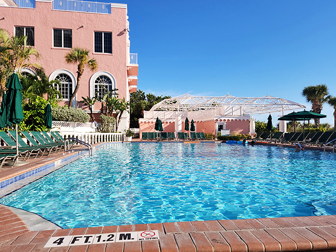 The hotel's sparkling pool area offers a refreshing oasis where palm trees provide shade and attentive staff ensure your glass is never empty.