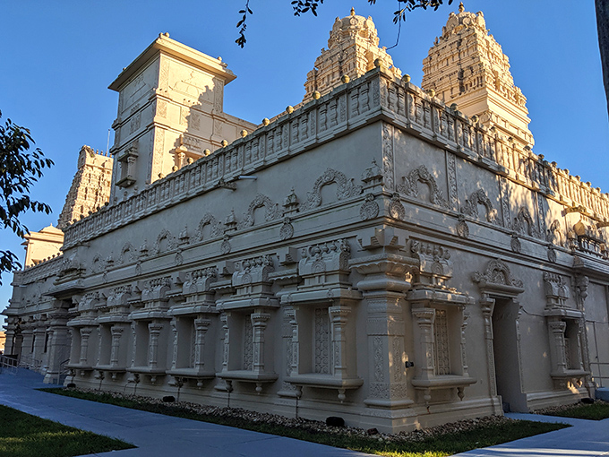 Intricate carvings tell ancient stories in stone, each figure frozen mid-narrative as if paused during the world's most elaborate divine soap opera.