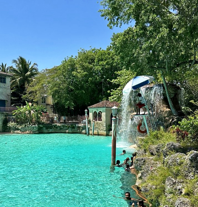 From this vantage point, swimmers become tiny specks in a vast turquoise canvas, framed by swaying palms and century-old architecture.