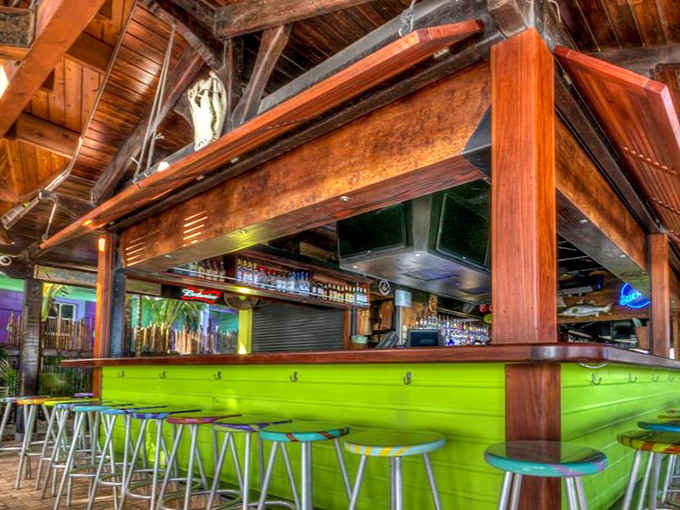 Square Grouper's vibrant green bar glows with island energy, inviting patrons to belly up for a cold one after a day on the water.