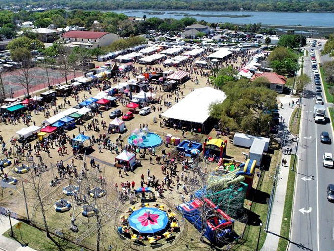 Families enjoy the festive atmosphere at St. Augustine's Spring Festival, with carnival rides and games filling the historic waterfront area.