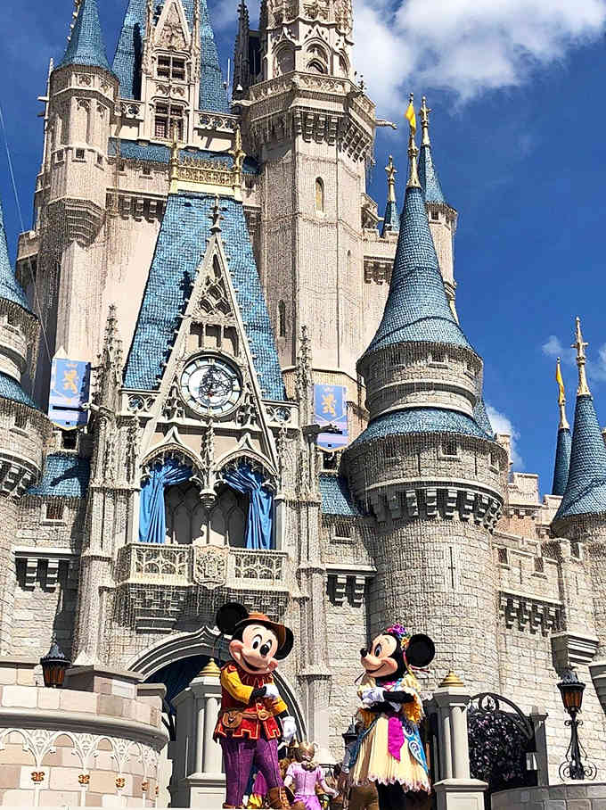 A closer view reveals the castle's intricate details, with beloved Disney characters adding magic to this enchanting centerpiece of the Magic Kingdom.