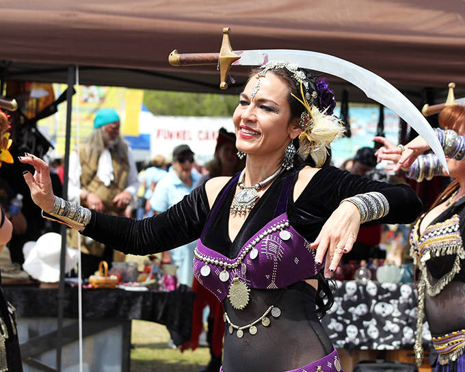 A performer entertains the crowd at St. Augustine's Spring Festival, where sword balancing and cultural dances add to the excitement.
