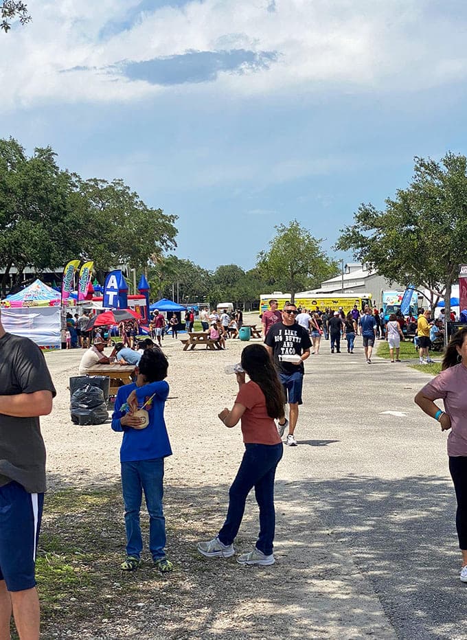 Families stroll through festival grounds where colorful tents and food trucks promise delicious discoveries around every corner.