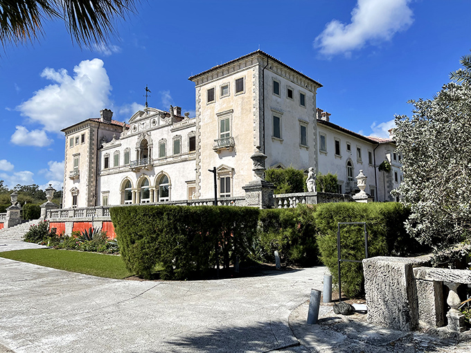 The elegant white fa&ccedil;ade of Vizcaya Museum stands proudly against Florida's blue skies, its formal gardens inviting exploration.